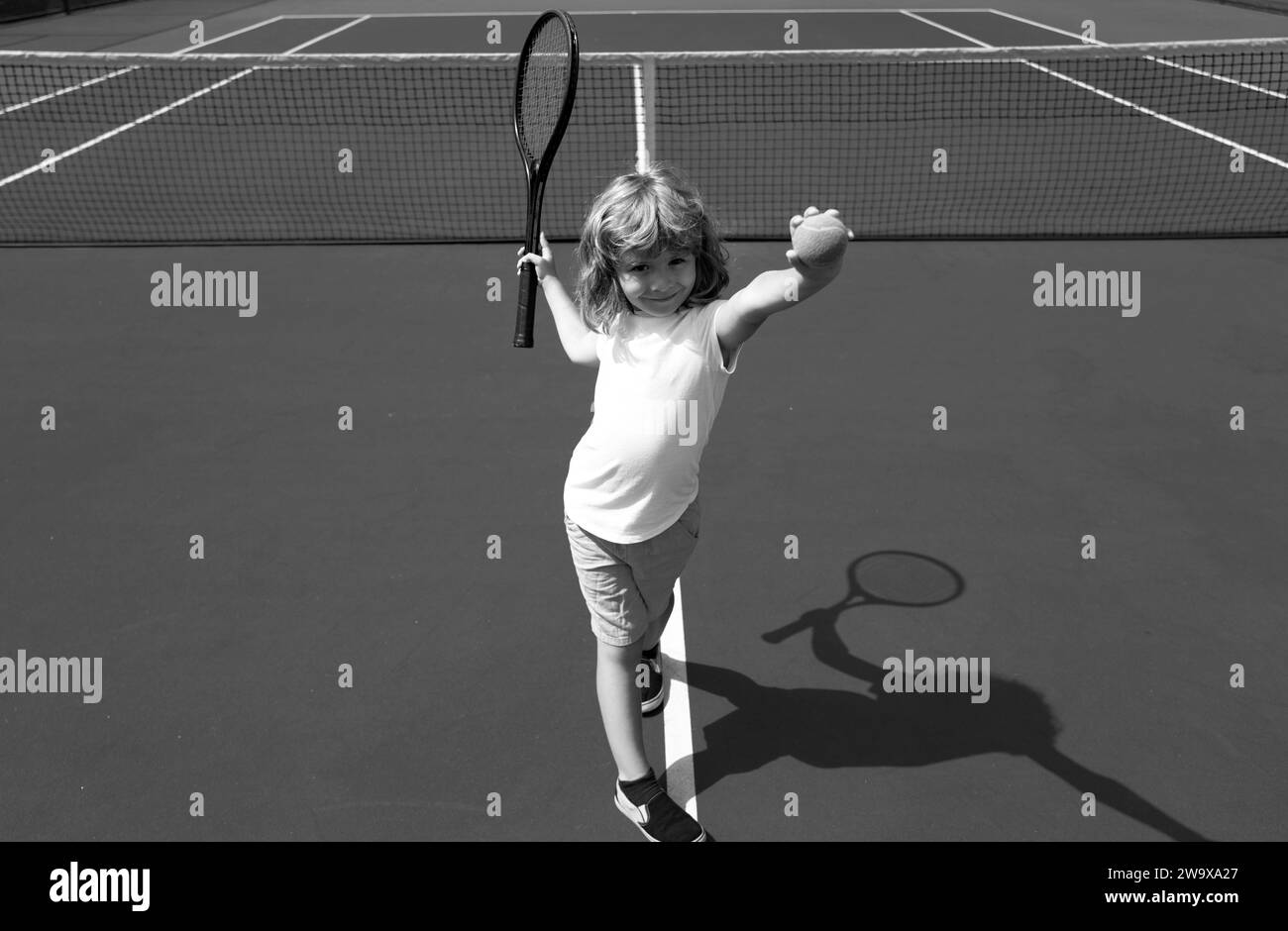 Child boy playing tennis on outdoor court. Little girl with tennis ...