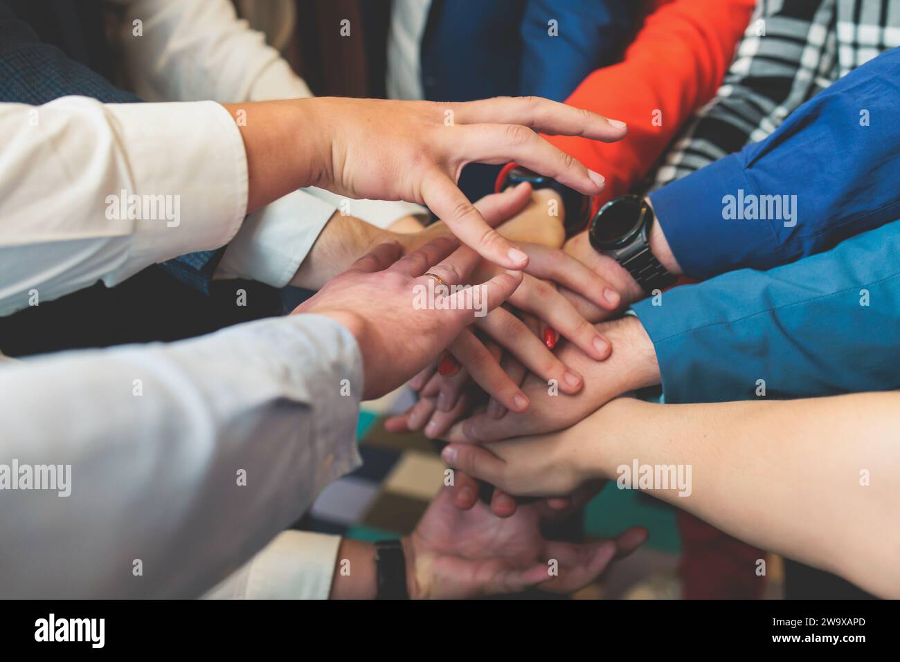 Group team of young people stacking hands together during contest ...