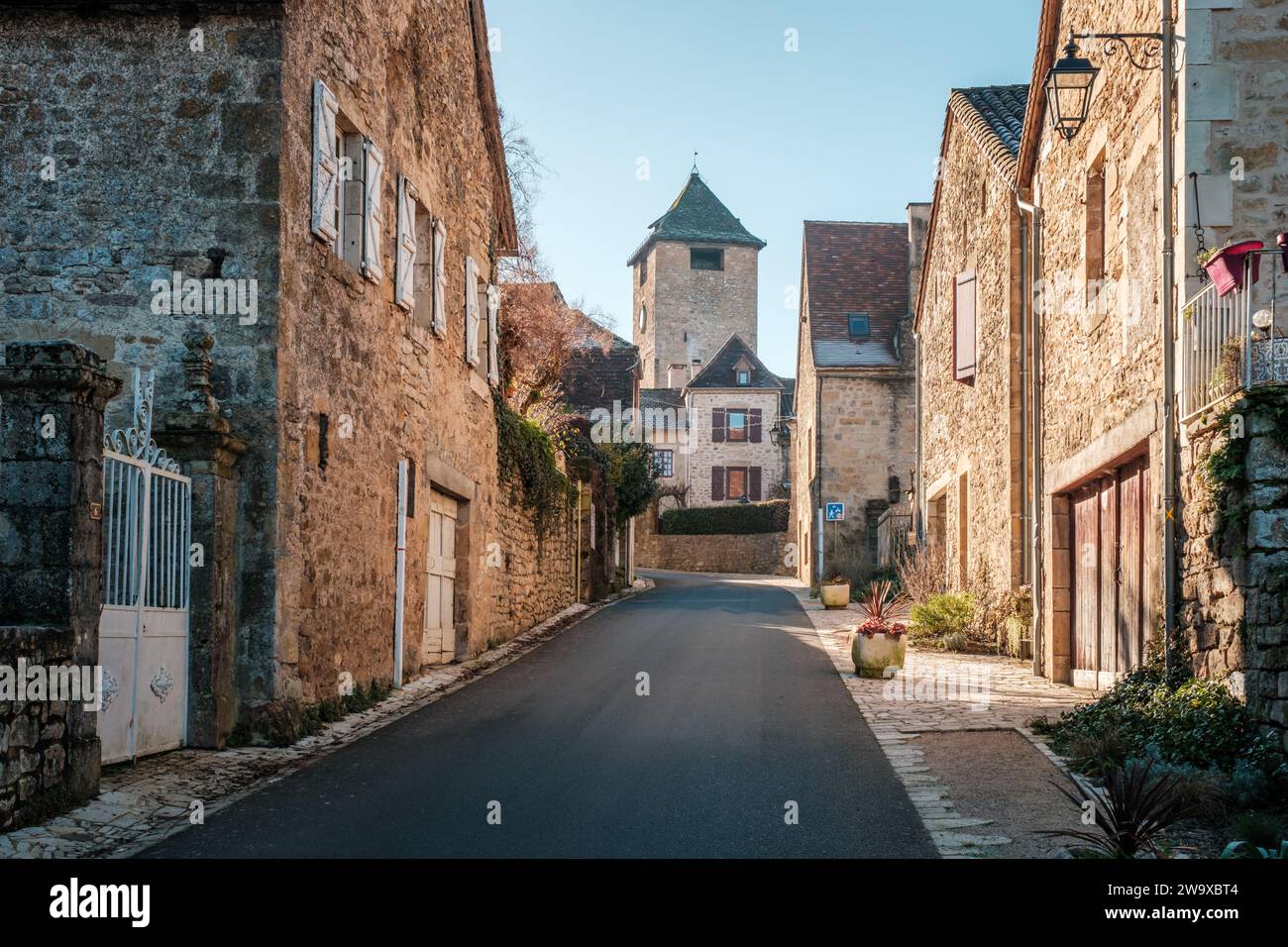 The church tower of the medieval village of Autoire on a frosty winters ...