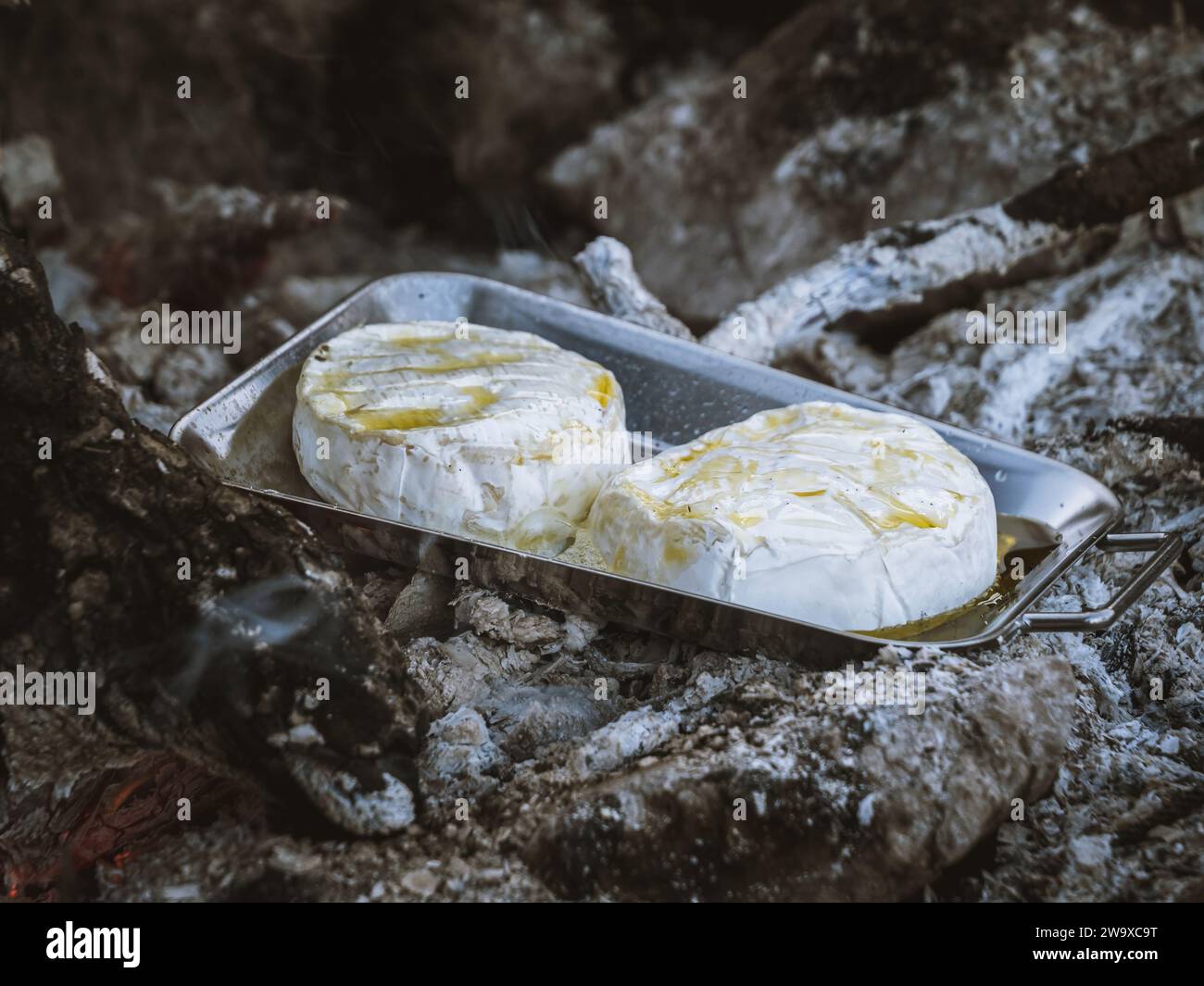 Closeup view of camembert cheese being grilled during an outdoor ...