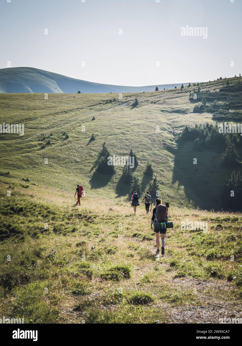 Group of adult backpacker hiker persons walking through a mountain ...