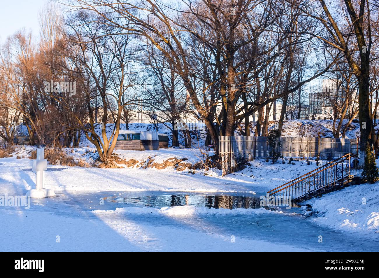 Holidays of Orthodox baptism. Ice cross hole and a cross of ice in ...