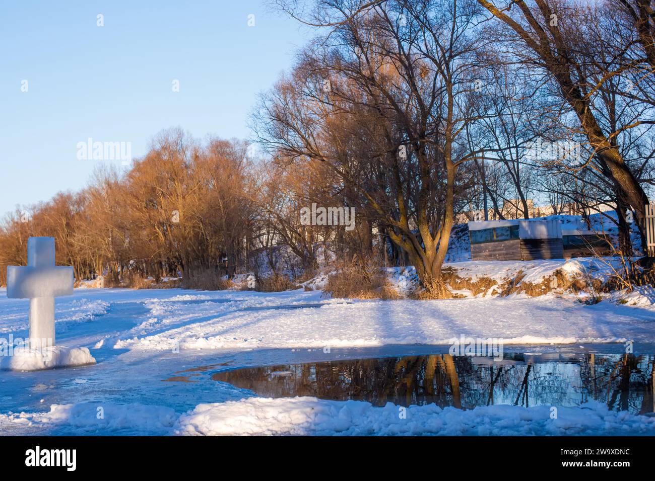 Holidays of Orthodox baptism. Ice cross hole and a cross of ice in ...