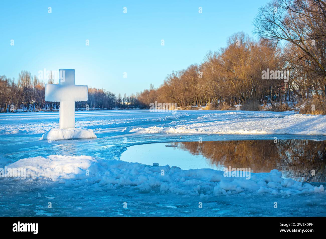 Holidays of Orthodox baptism. Ice cross hole and a cross of ice in ...