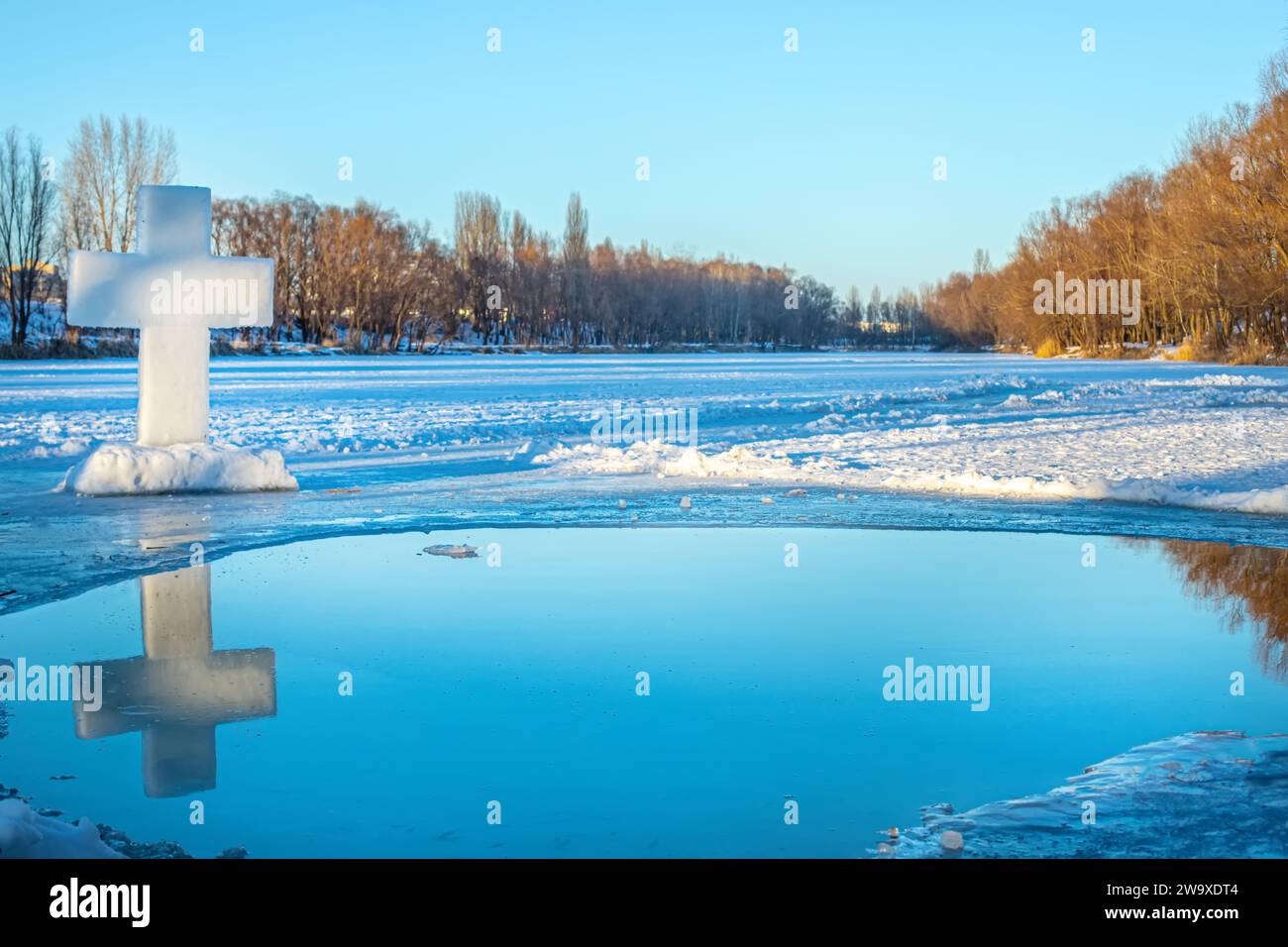 Holidays of Orthodox baptism. Ice cross hole and a cross of ice in ...