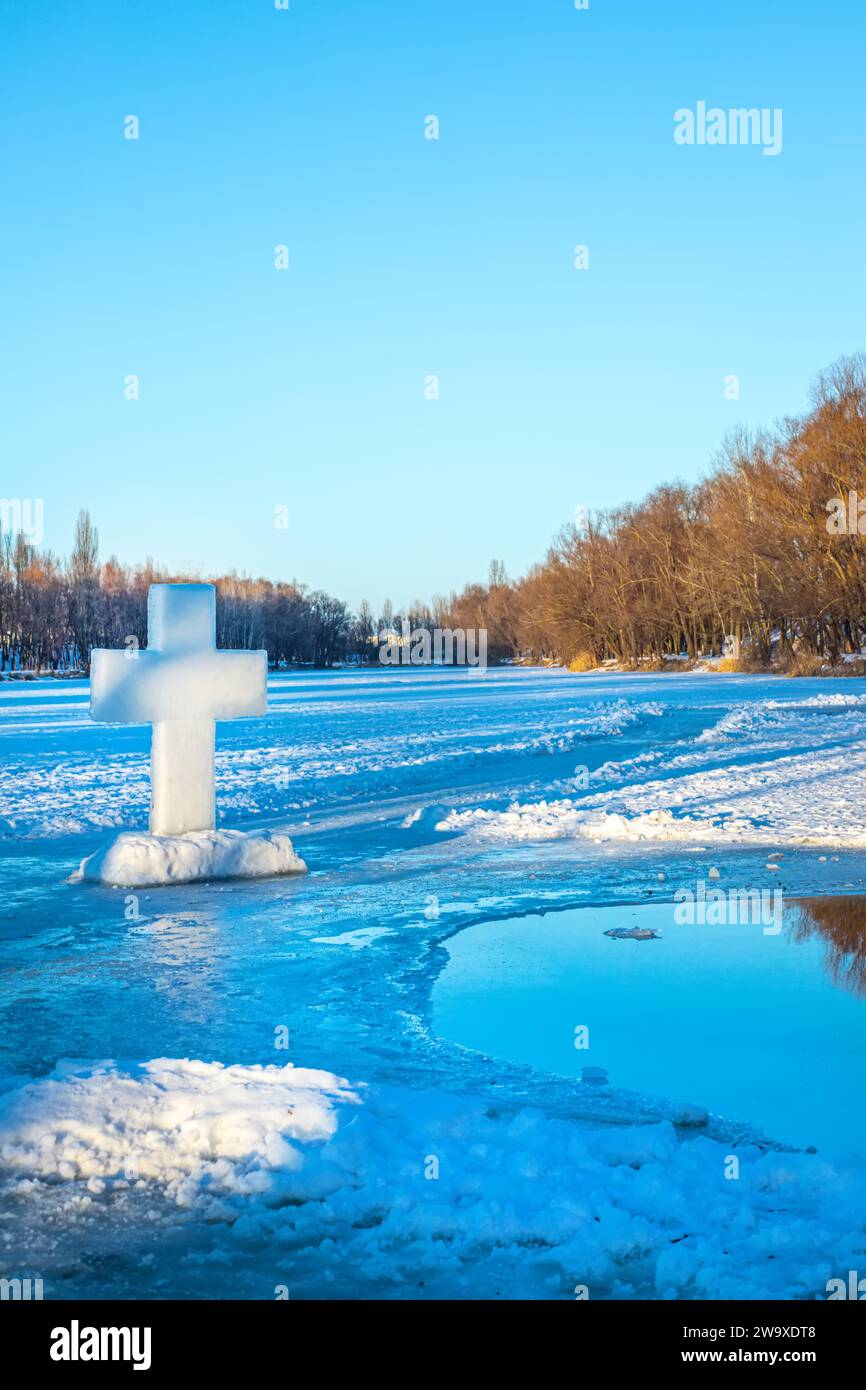 Holidays of Orthodox baptism. Ice cross hole and a cross of ice in ...