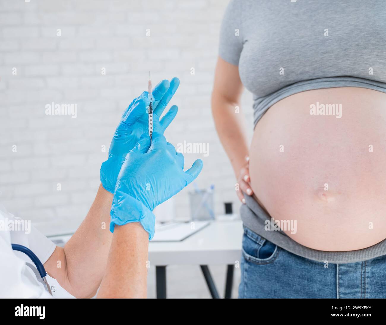 Doctor gives an injection in the stomach of a pregnant woman Stock ...