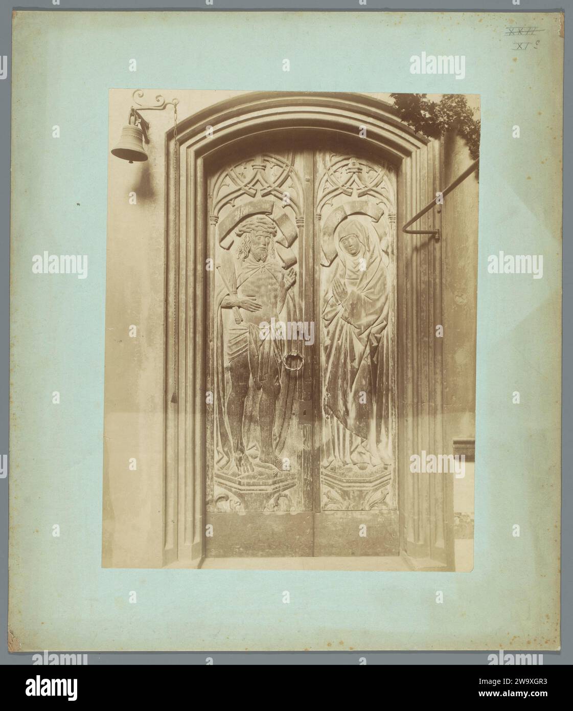 Gate with sacristy door with a relief with Christ and Mary in the Sint ...