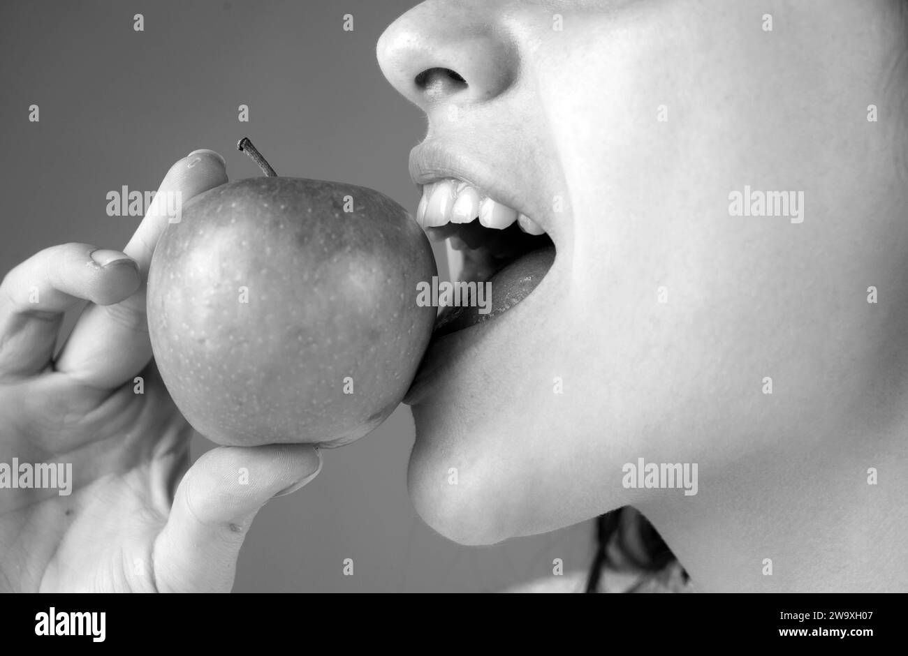 Female biting an apple. Open mouth woman about to bite green apple ...