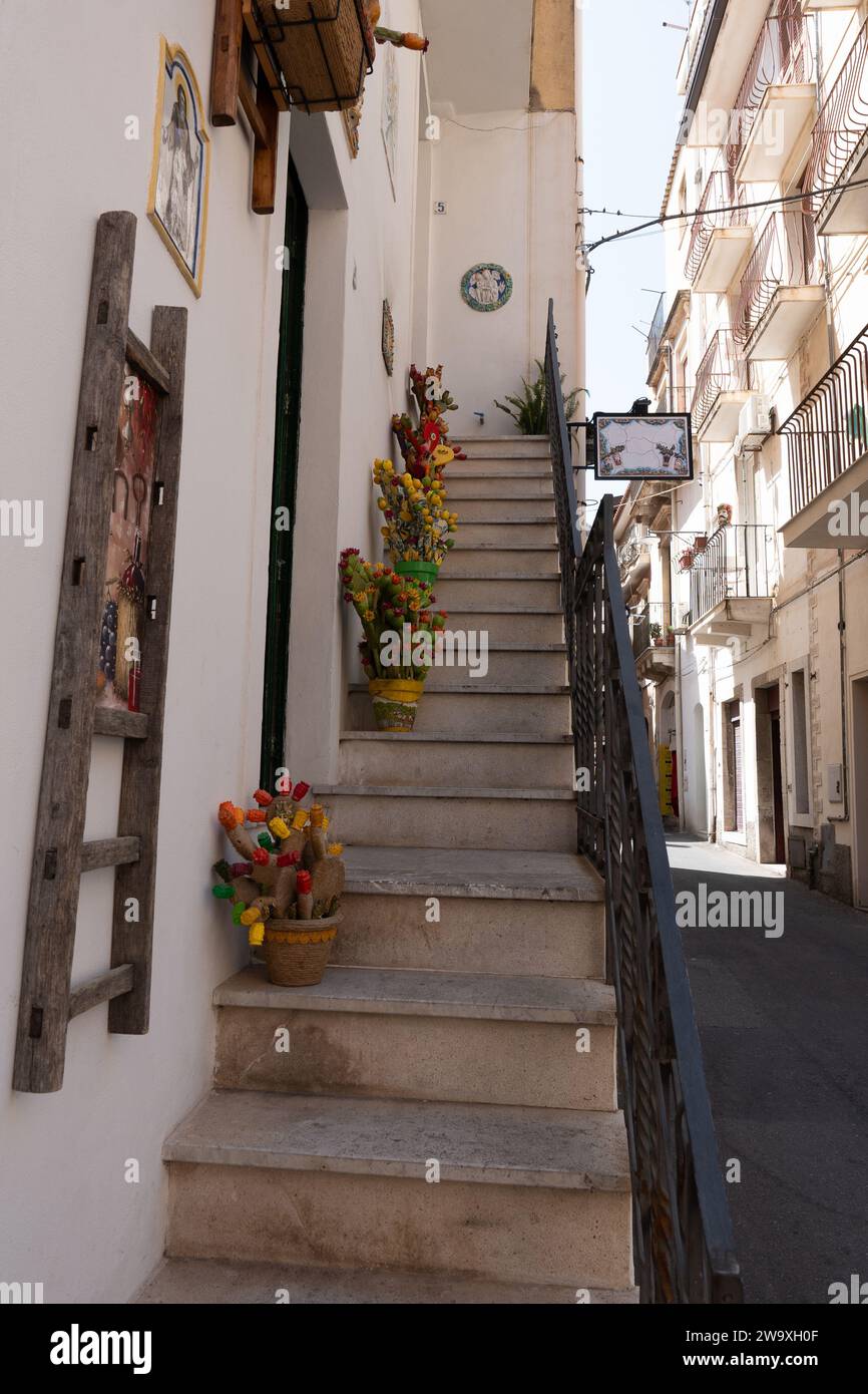 Buildings stairs with potted plants. Colorful pots on steps of a ...