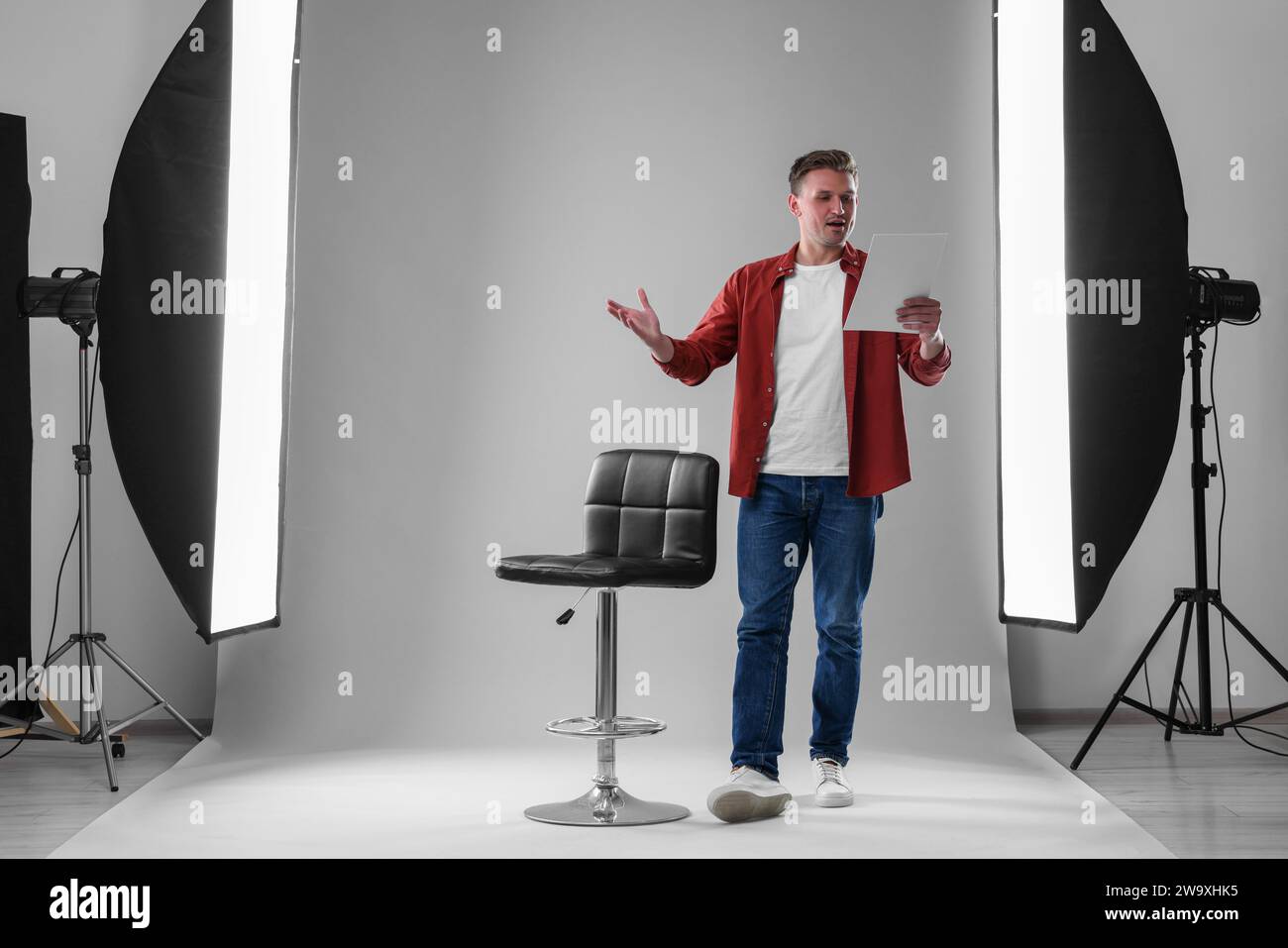 Casting call. Man with script performing in studio Stock Photo - Alamy