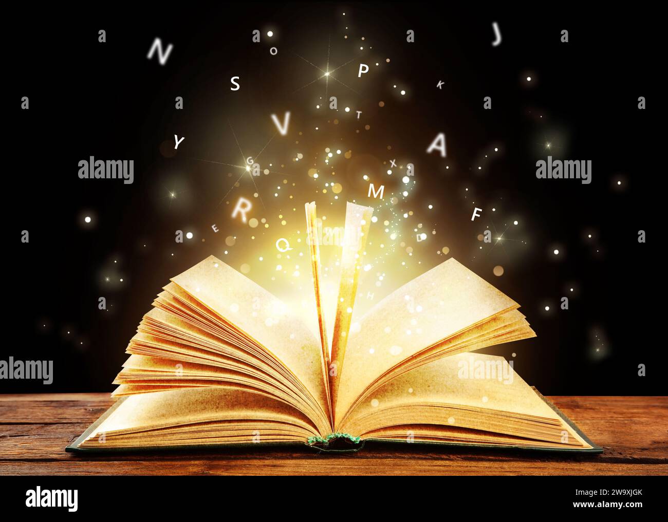Open book with magic light and glowing letters flying out of it on ...