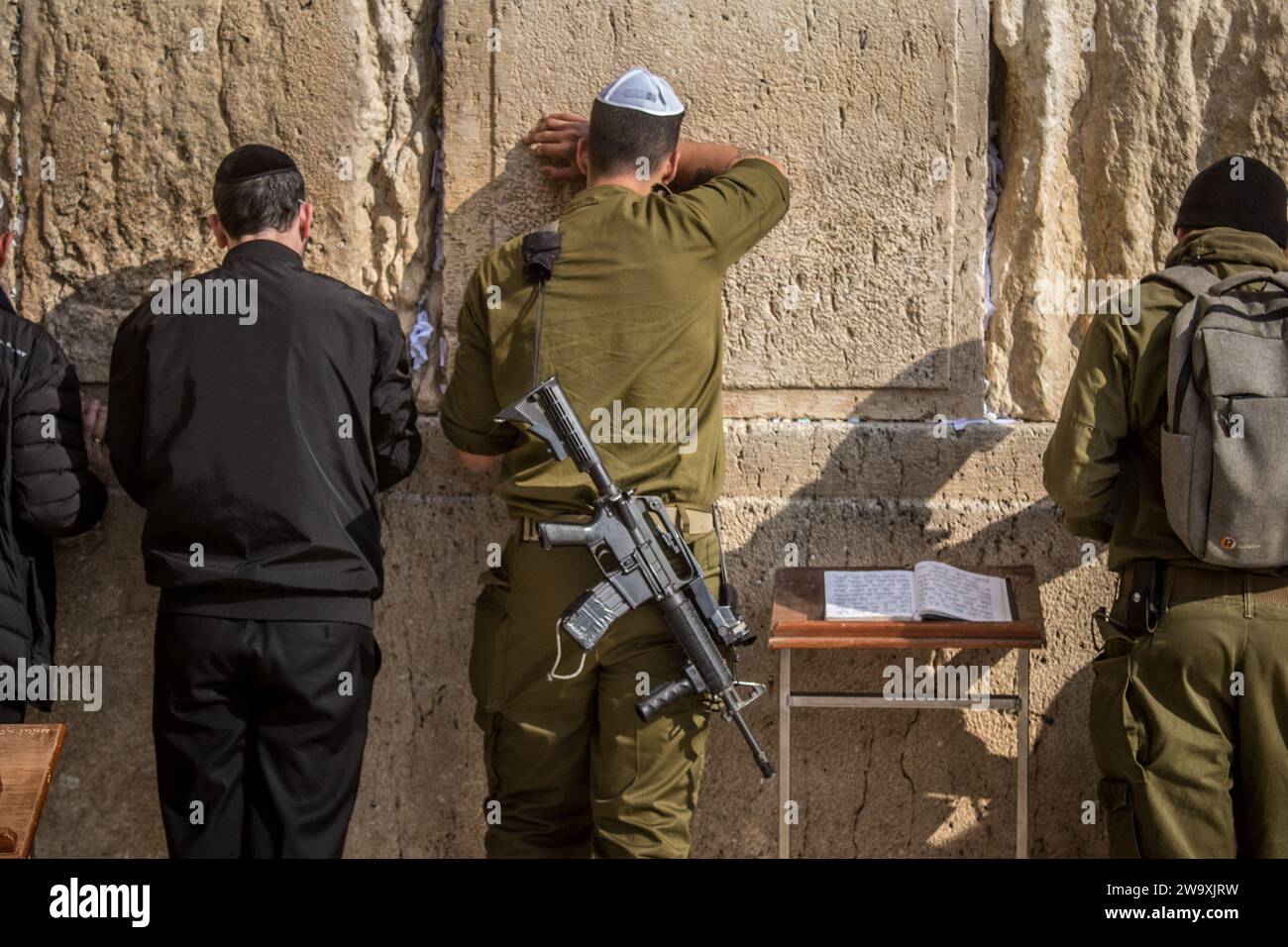 An IDF soldier prays at the Western Wall in Jerusalem. Soldiers ...