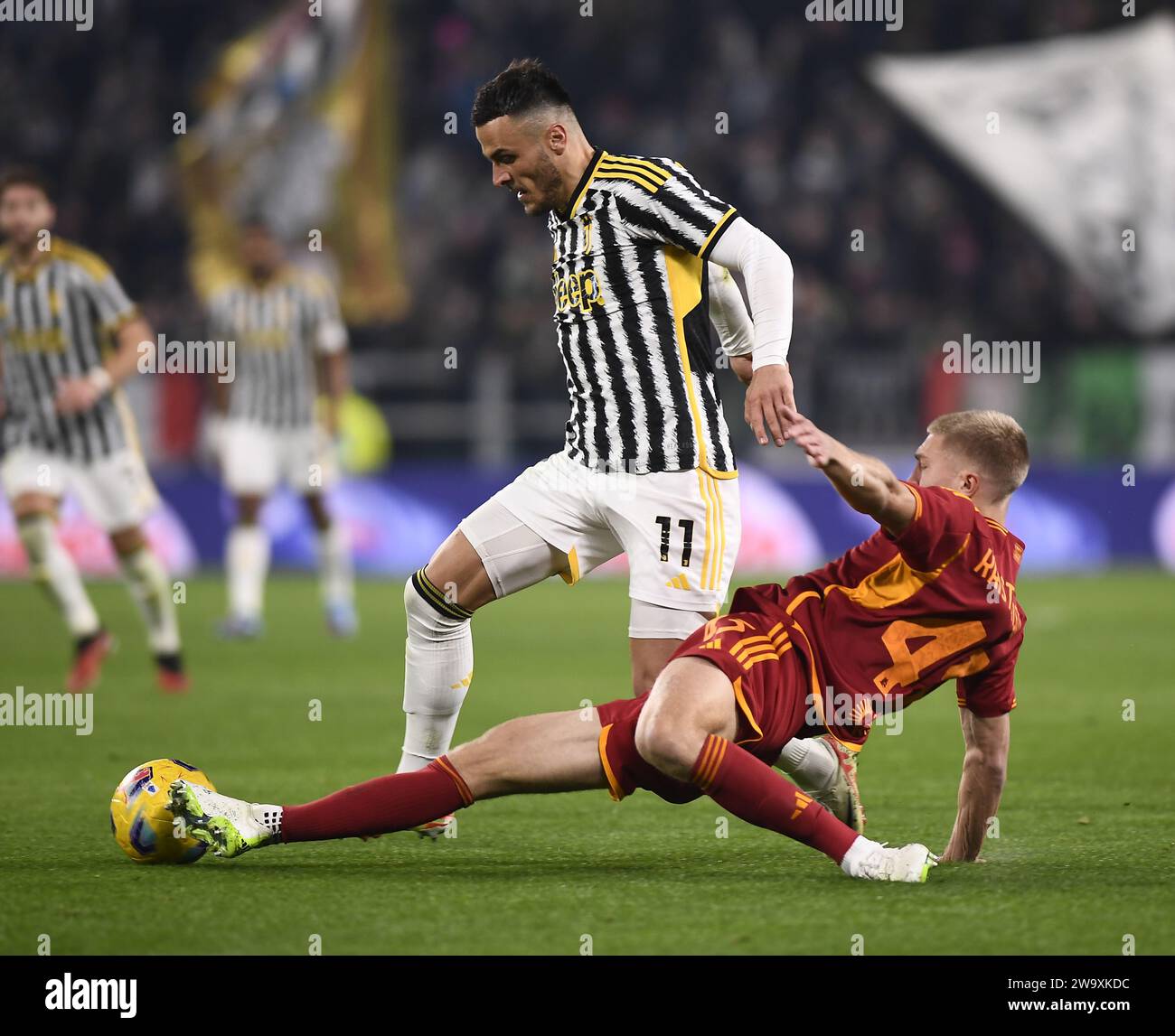 Turin, Italy. 30th Dec, 2023. FC Juventus' Filip Kostic (L) vies with ...