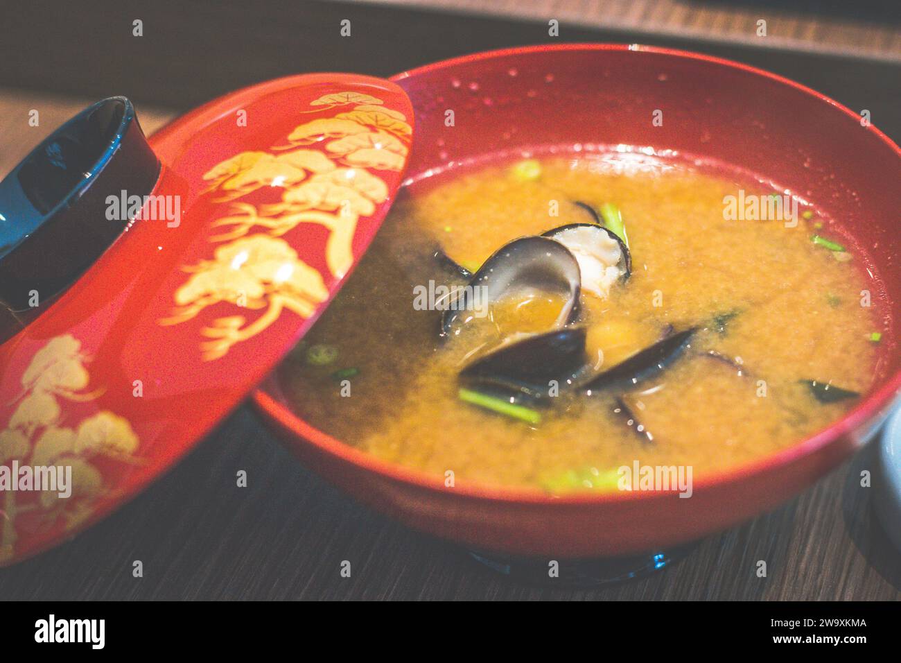 a serving of red bean miso soup with river clams served in a ...
