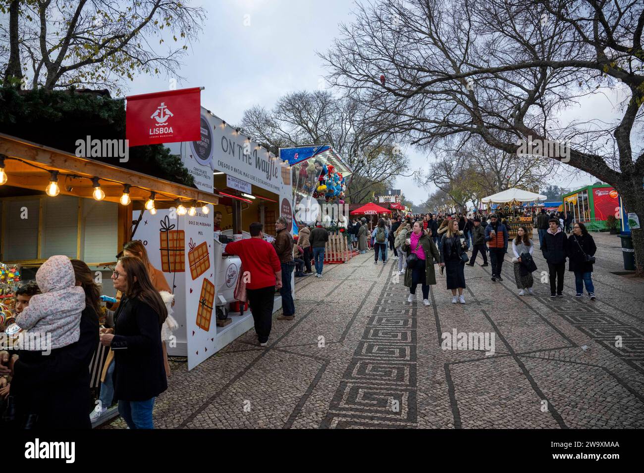 Lisbon, Portugal. 30th Dec, 2023. People walk through the aisles of a ...