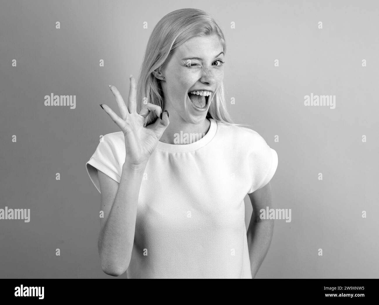 Laughing woman showing OK gesture. Woman isolated on white background ...