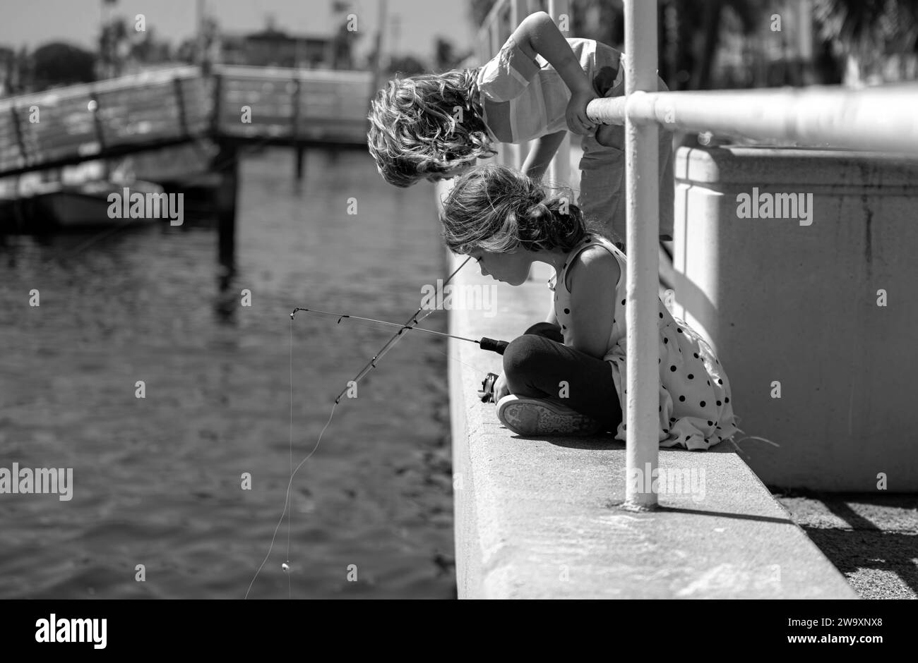 Two kids boy and girl fishing in a river or lake. Happy excited ...