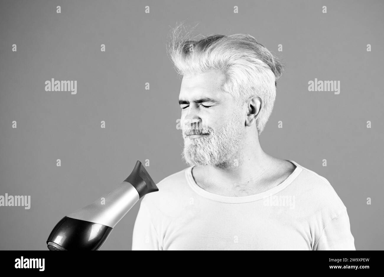 Blonde funny bearded man hair dry. Hair care male isolated Stock Photo ...
