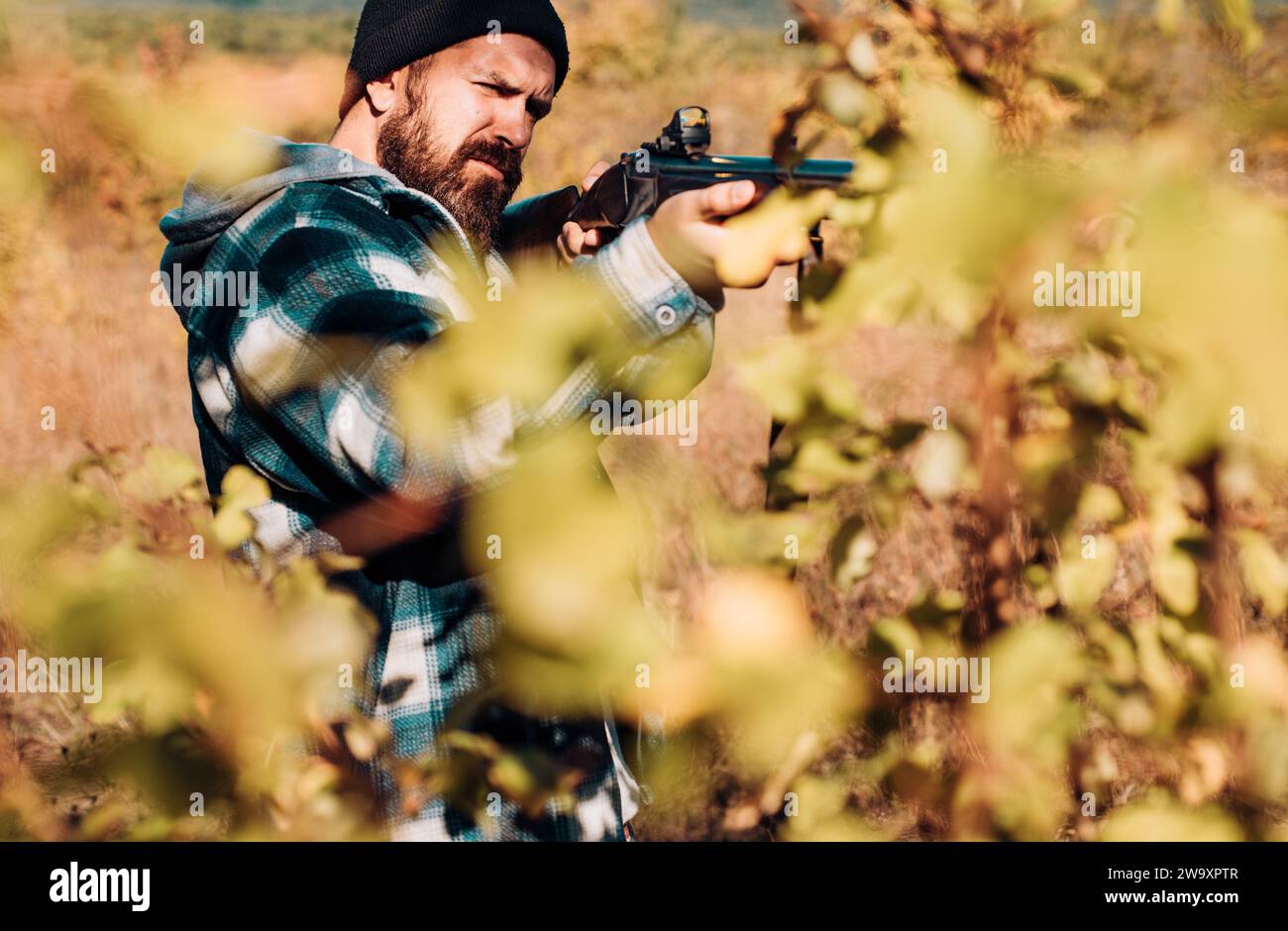 Hunter with a shotgun in a traditional shooting clothing. Hunter with ...