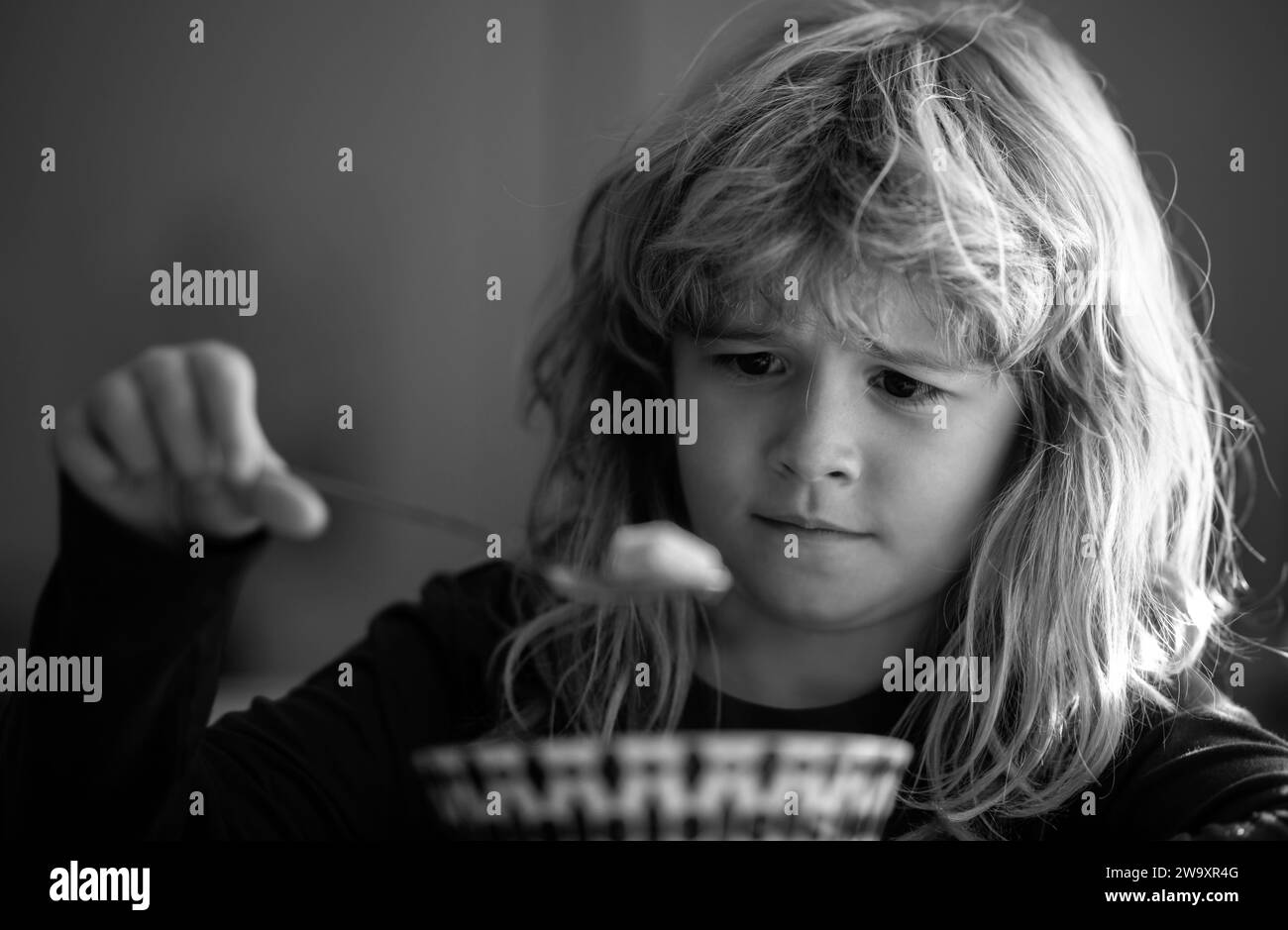 Cute child eating breakfast at home. Sad boy eating healthy chicken ...