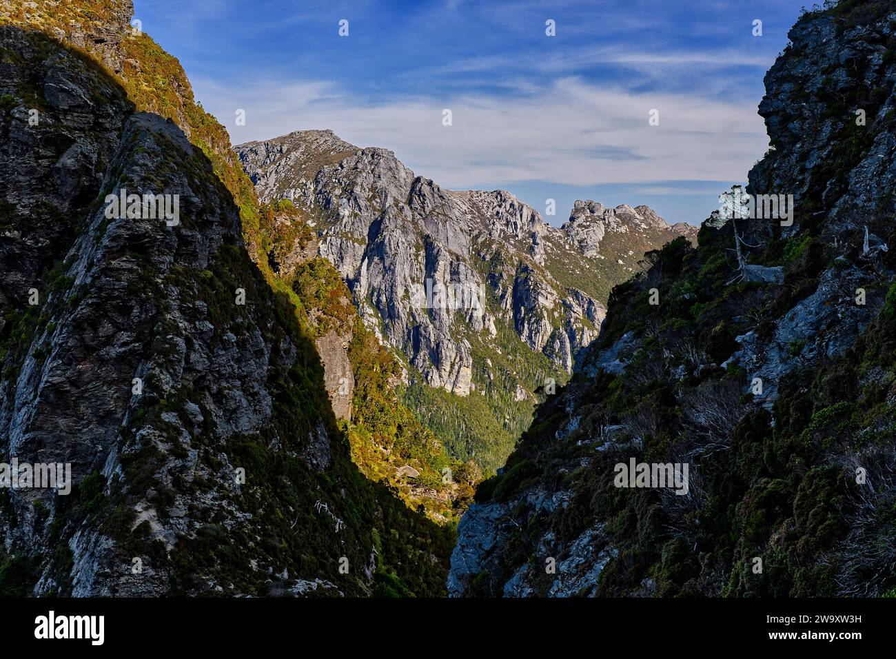 View of Barrons Pass through shaded valley on Frenchmans Cap climb ...
