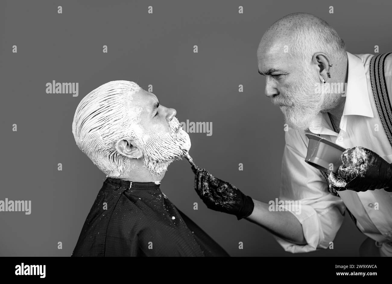 Coloring moustache. Hairdresser making of a color hair for a bearded ...