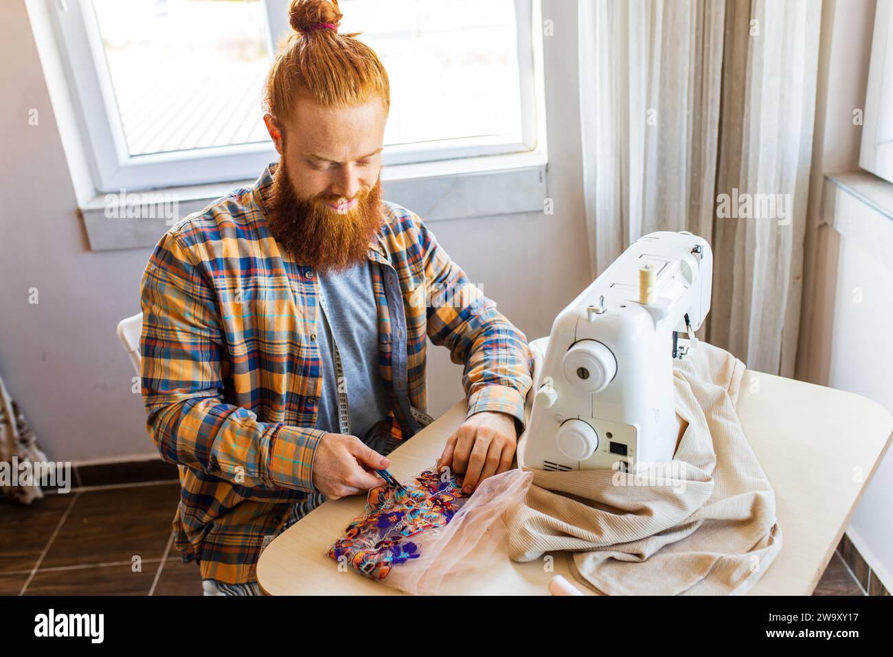 Man sews sewing machine designer hi-res stock photography and images ...