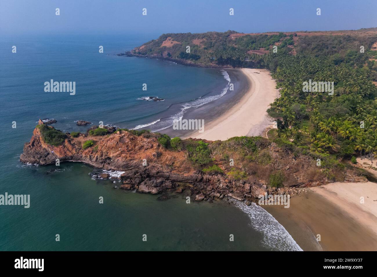 Aerial top view on tropical beach with green palm trees under sunlight ...