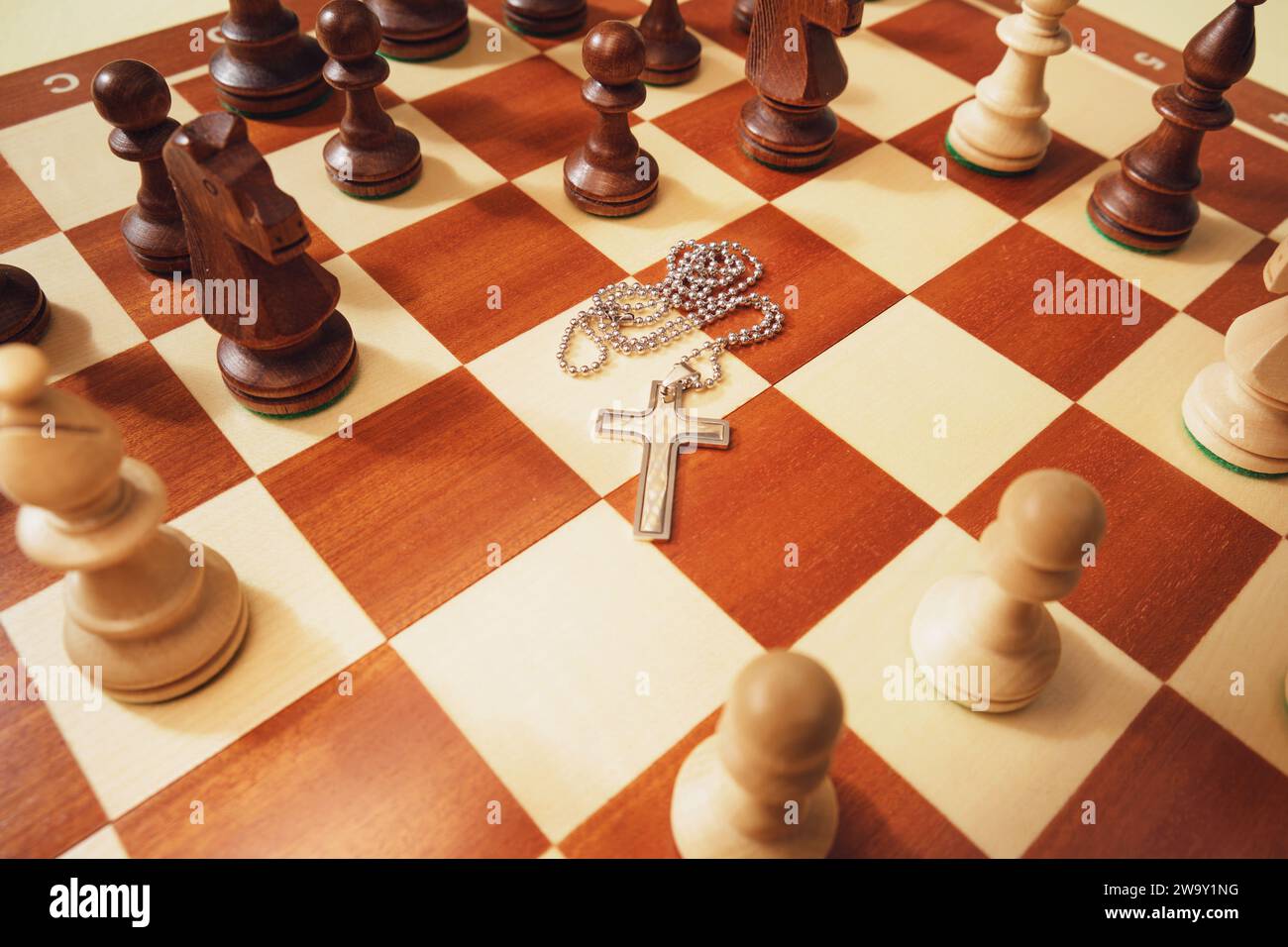 Catholic religious cross with chess pieces of kings on a chessboard ...