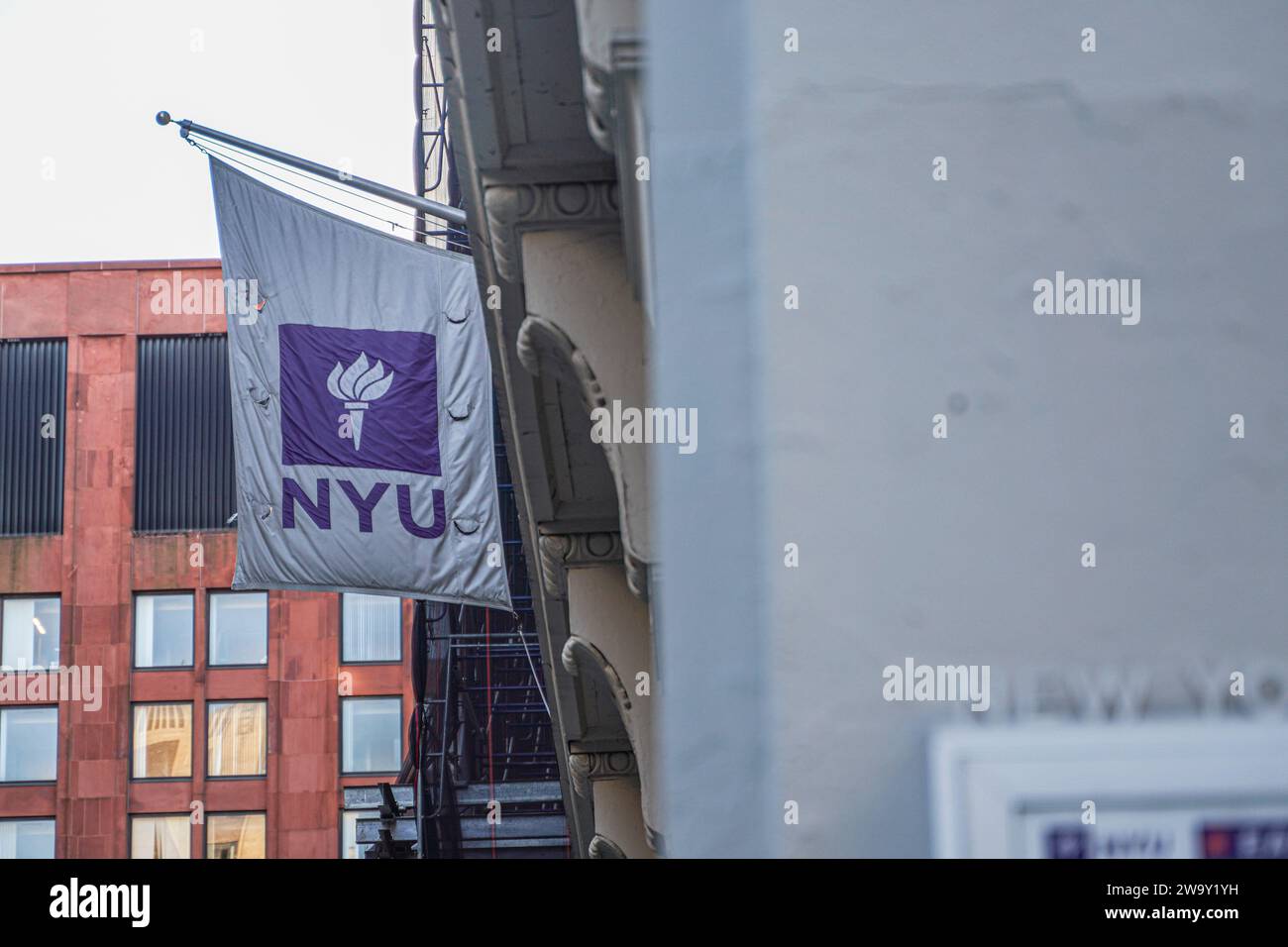 New York, USA. 28th Dec, 2023. A flag of New York University hangs on a ...