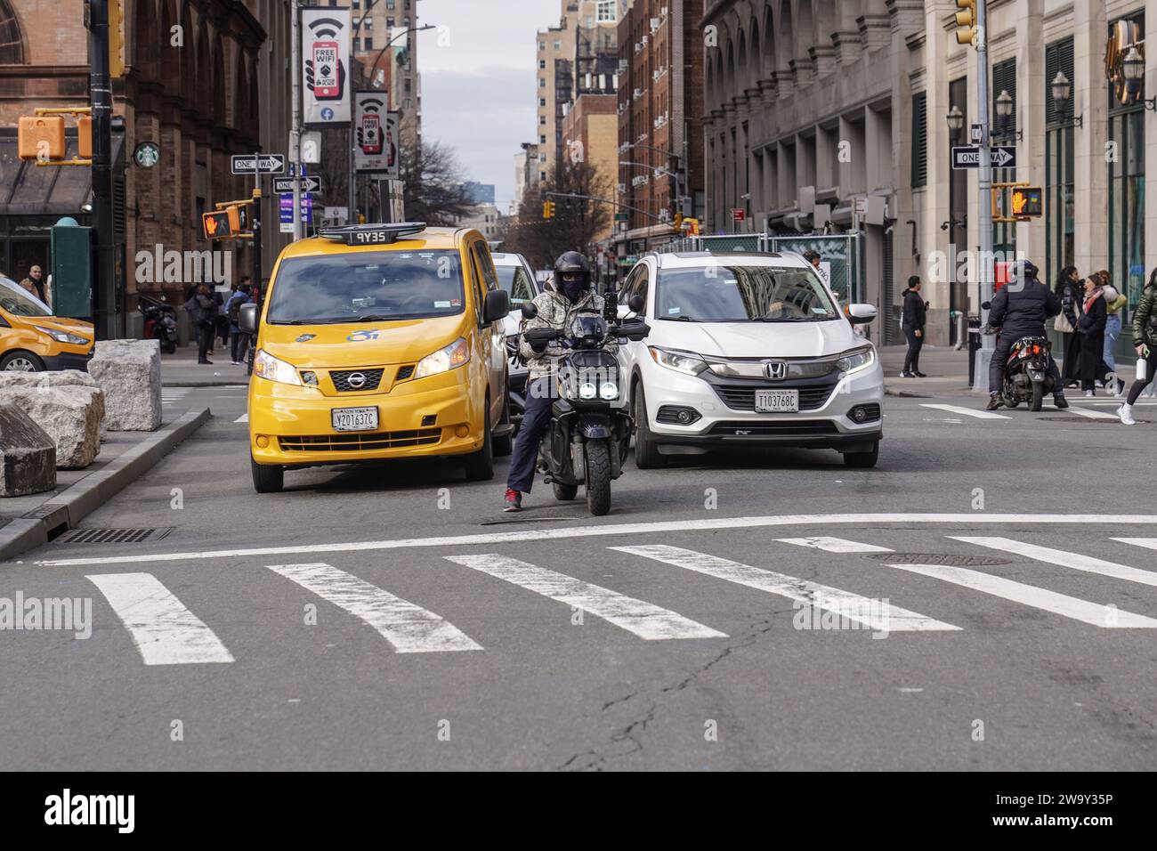 Cars and motorcycles is seen on the streets of New York City. Road ...