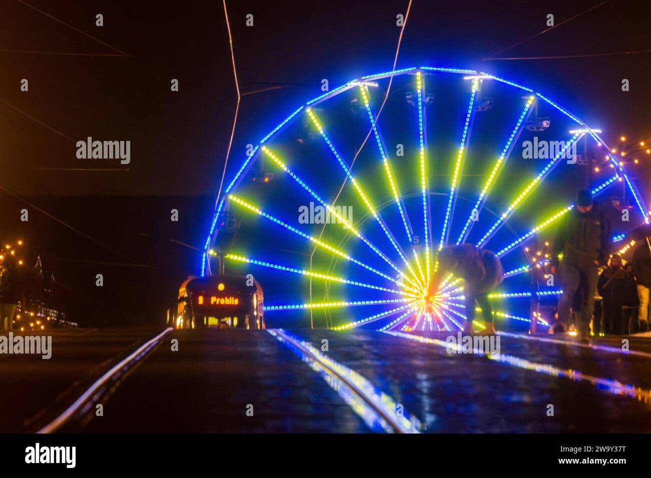 illuminated ferris wheel, bridge Augustusbrücke, streetcar tracks ...
