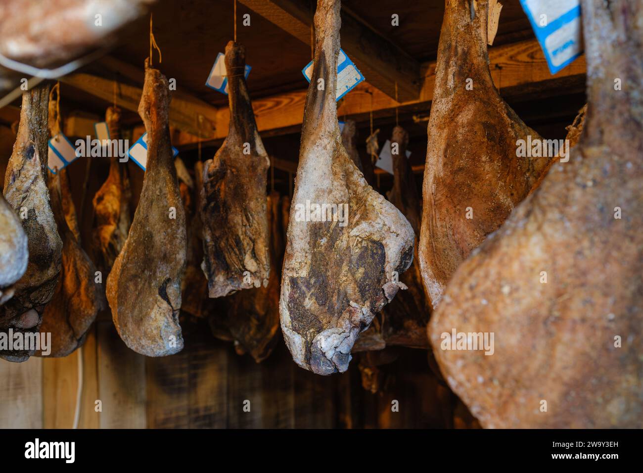 Aging hams hanging in a traditional curing room Stock Photo - Alamy