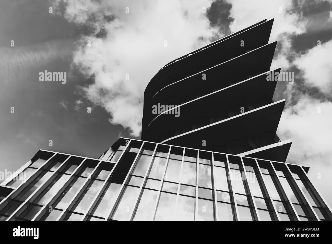 Stark black and white contrast of a modern building with a dynamic sky ...