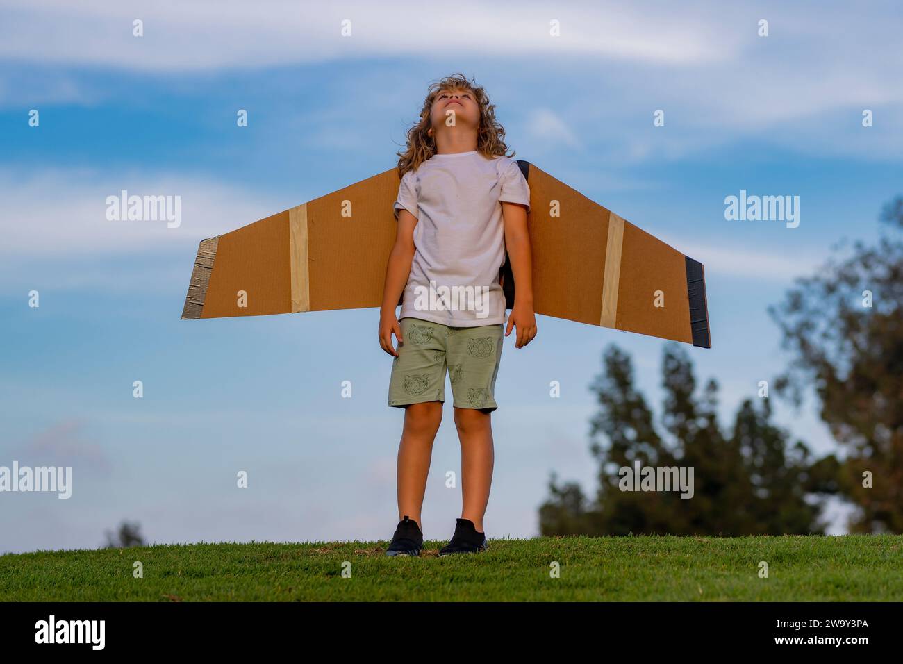 Child freedom and carefree. Kid pilot aviator with with paper wings ...