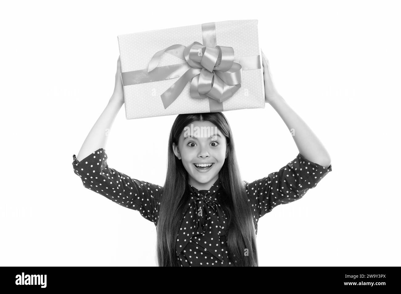 Child with gift present box on isolated studio background. Gifting for ...