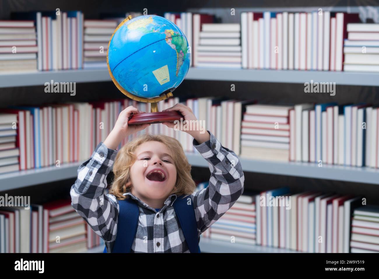 School and kids. Cute blonde child with a book learning. Knowledge day ...