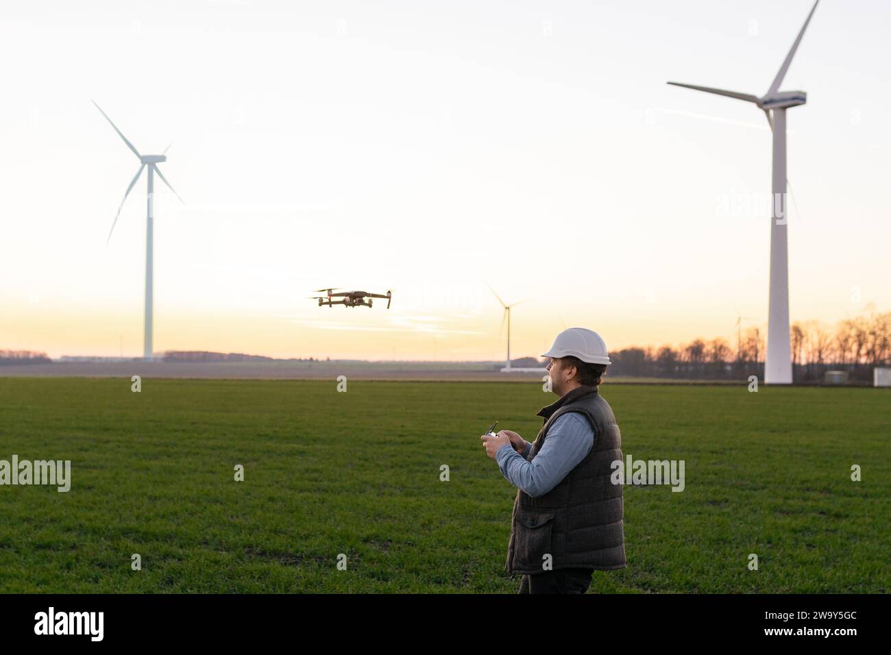 Technician Engineer in Wind Turbine Power Generator Station launches a ...