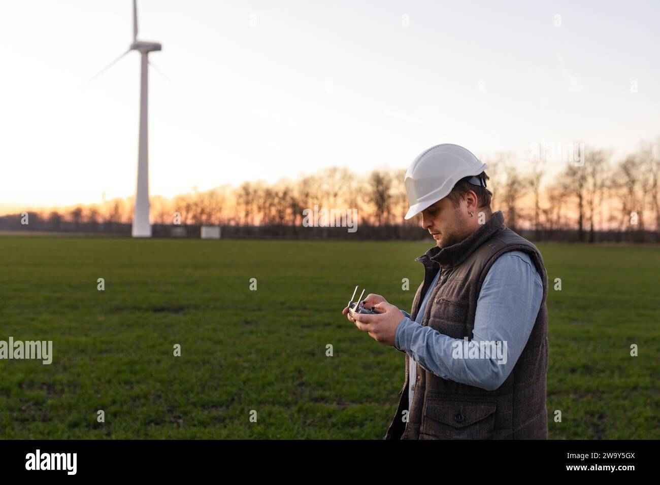 Technician Engineer in Wind Turbine Power Generator Station launches a ...