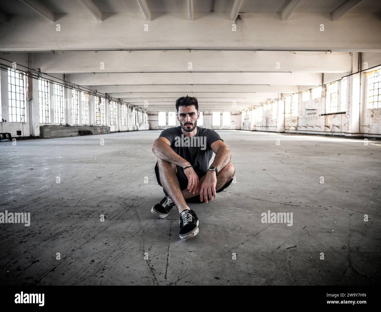 Man sitting on ground inside hi-res stock photography and images - Alamy