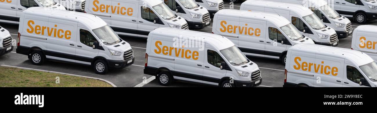 Service vans are parked in row. Commercial fleet Stock Photo - Alamy
