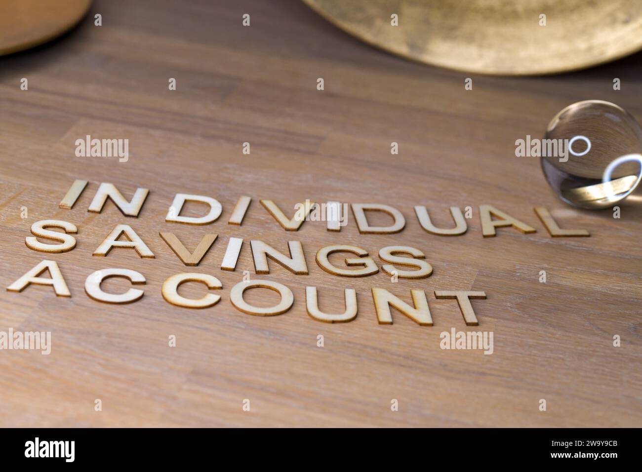 ISA, Individual Savings Account in wooden letters on a wooden surface ...