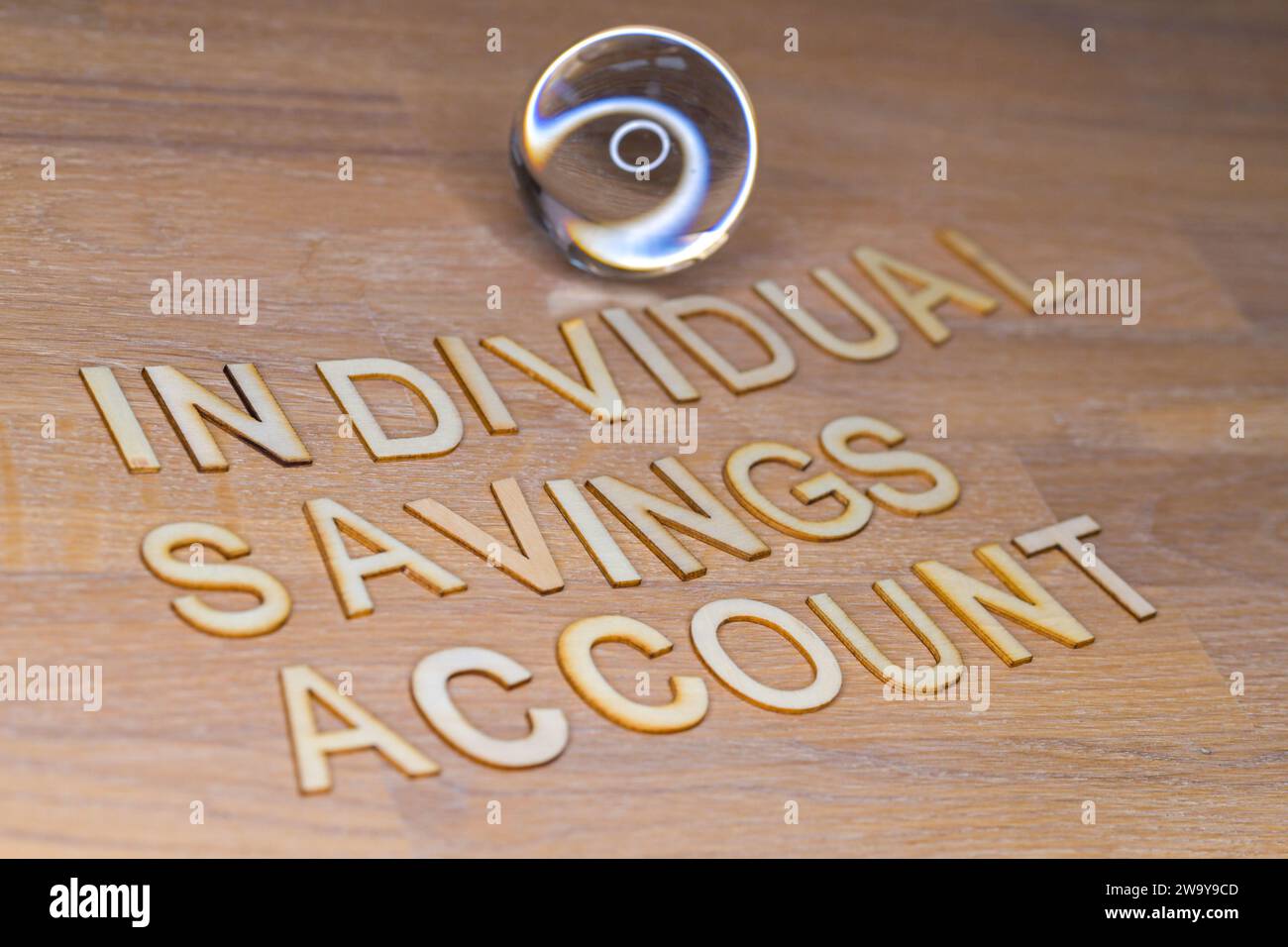 ISA, Individual Savings Account in wooden letters on a wooden surface ...