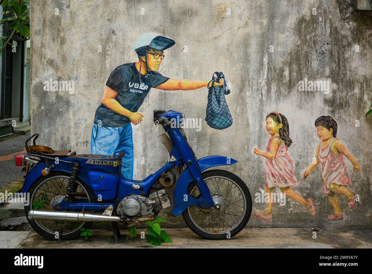 Uber delivery rider on a Scooter Handing Bag To Children, Ipoh Street ...