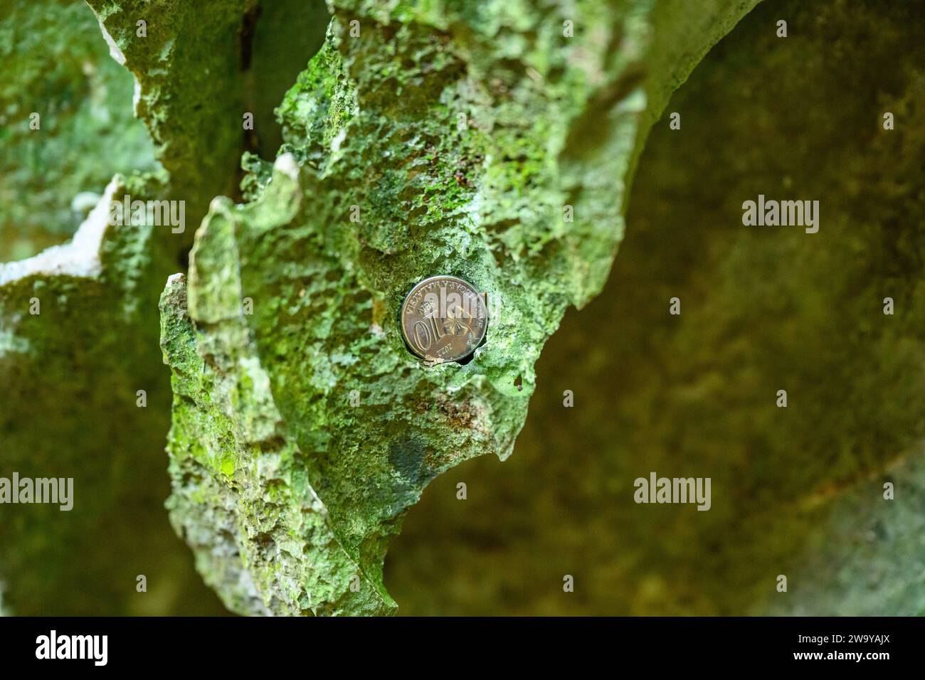 Coins on rock face hi-res stock photography and images - Alamy