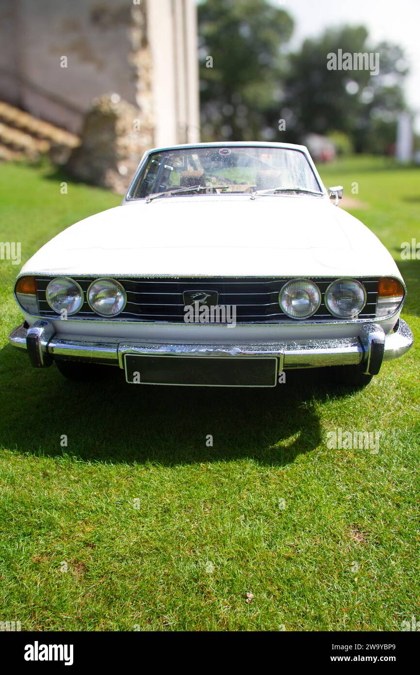 White vintage Triumph Stag convertible sports car, with no driver or ...