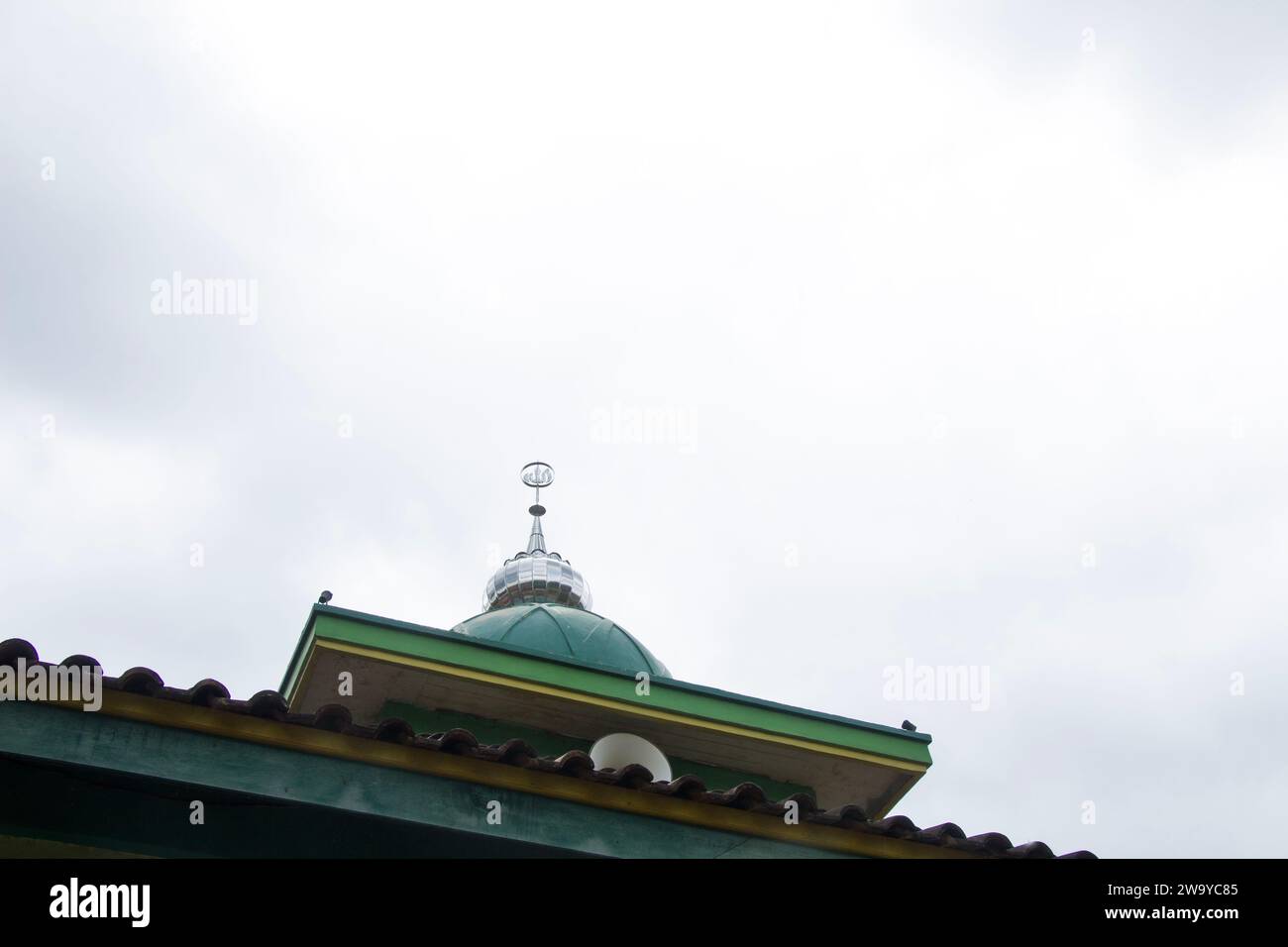 bottom view of traditional green dome mosque and mosque loudspeaker ...