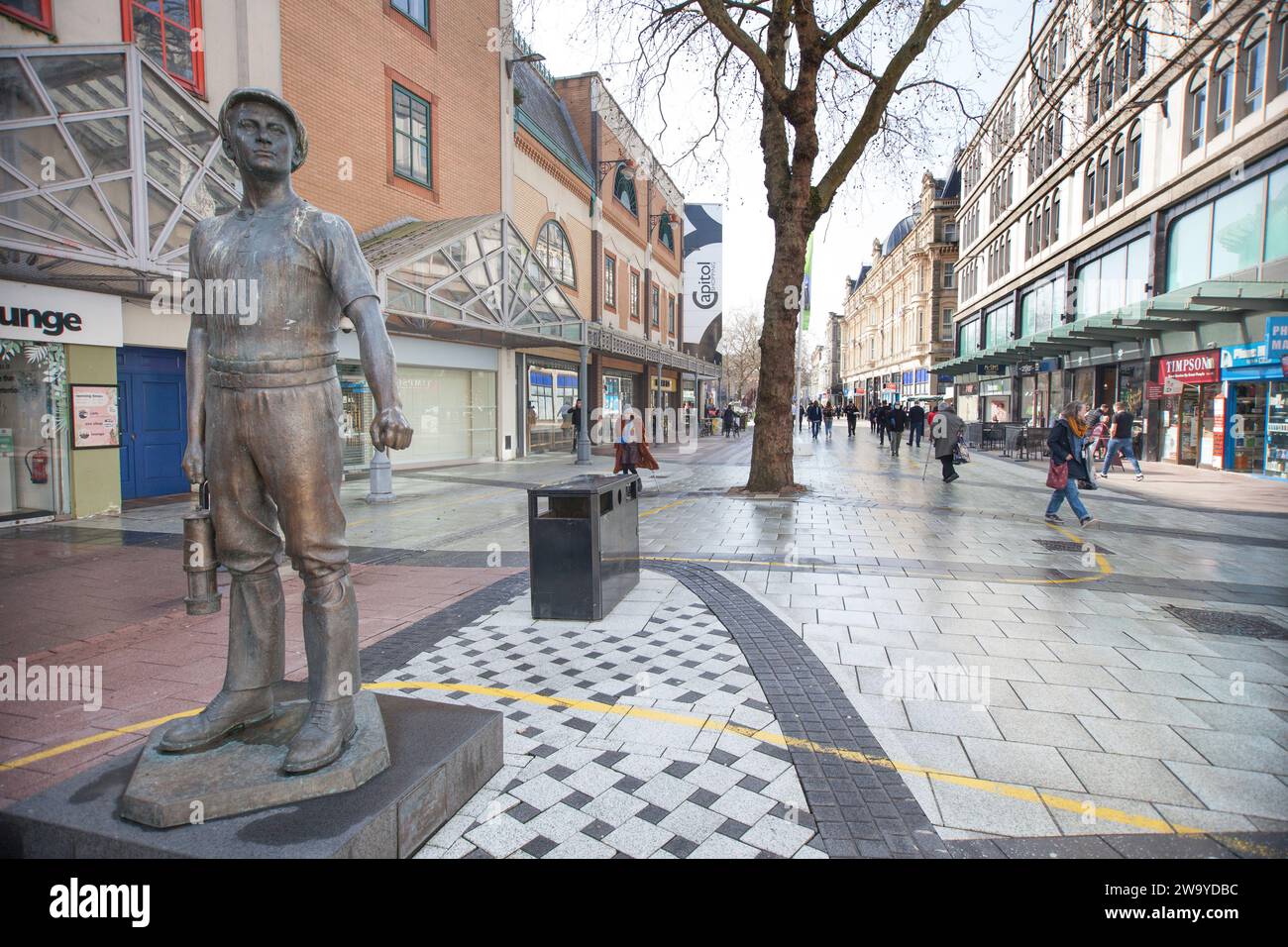 Views of shops and a miner's statue on Queen Street in Cardiff, Wales ...