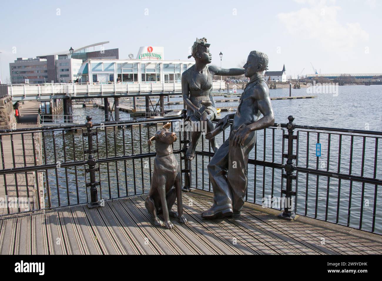 A statue of a man a woman and a dog at Cardiff Bay in Cardiff in the UK ...